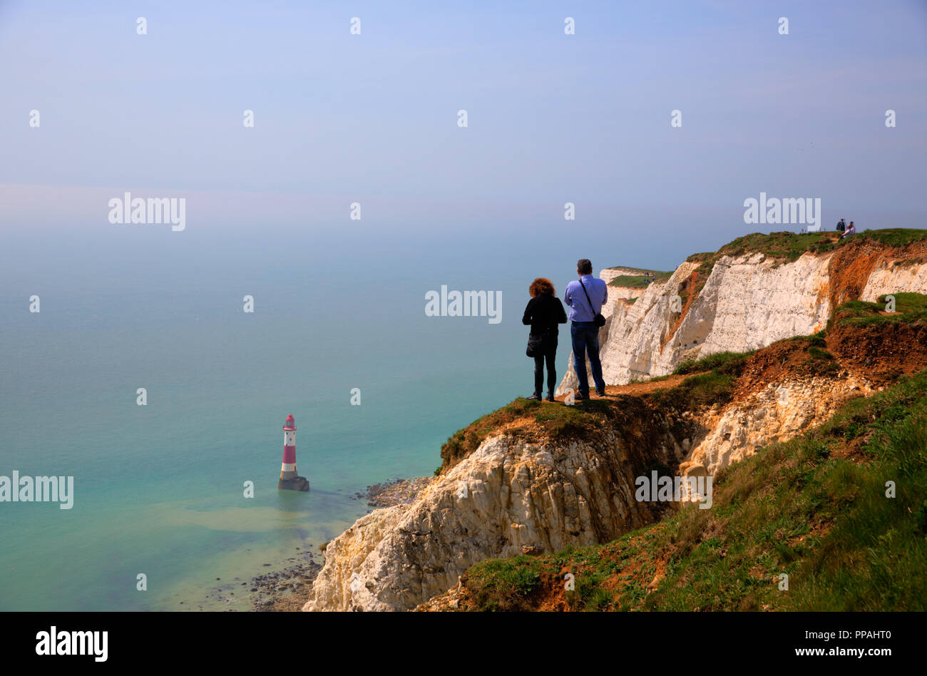 Beachy Head England UK people on the edge at the famous steep cliffs ...