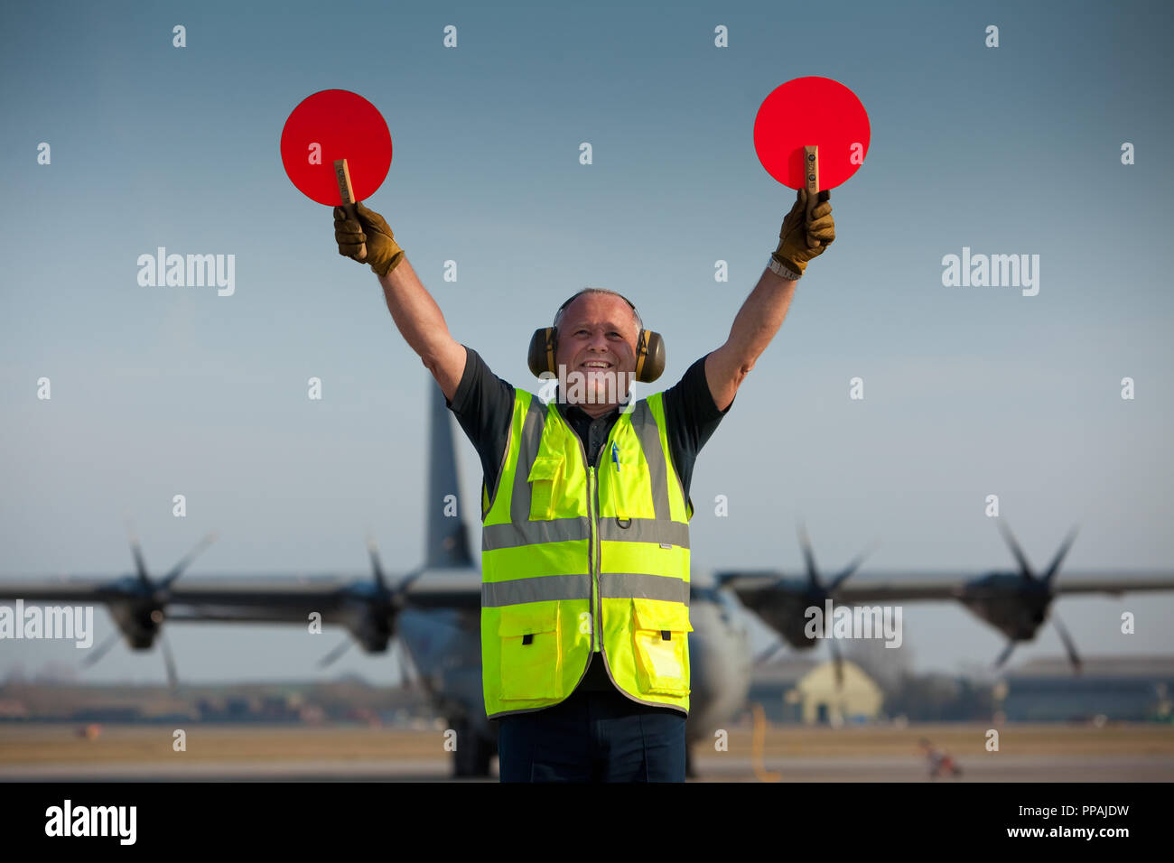 Aircraft marshall on runway Stock Photo - Alamy