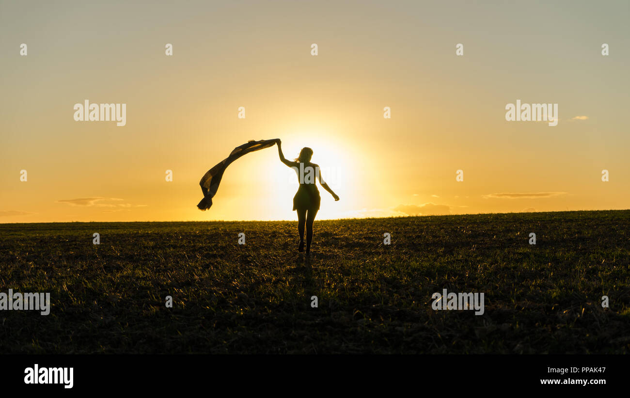 Girl Walking into The Sunset Stock Photo - Alamy