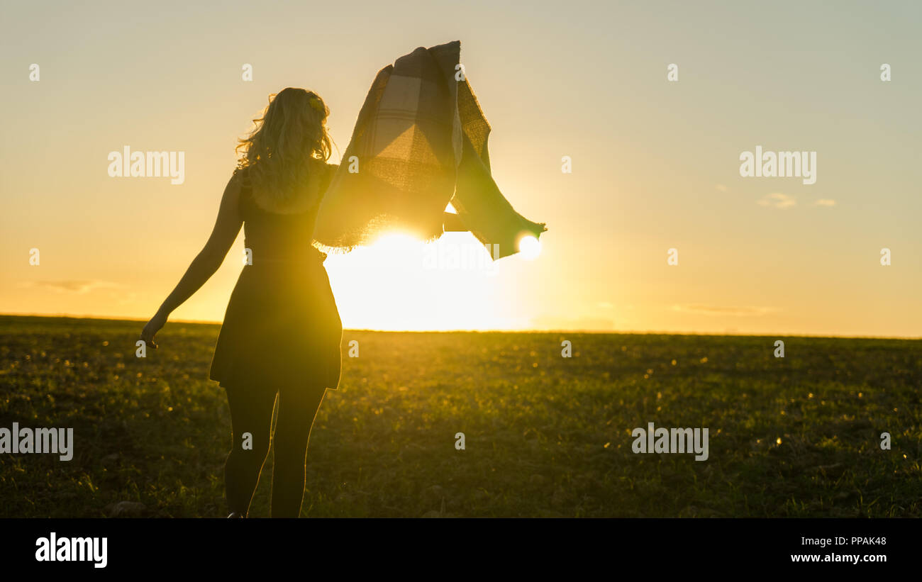 Girl Walking into The Sunset Stock Photo - Alamy