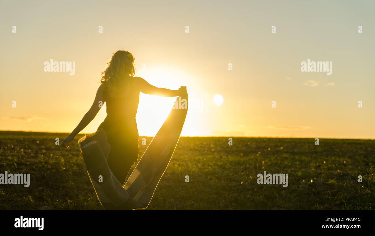 Girl Walking into The Sunset Stock Photo - Alamy