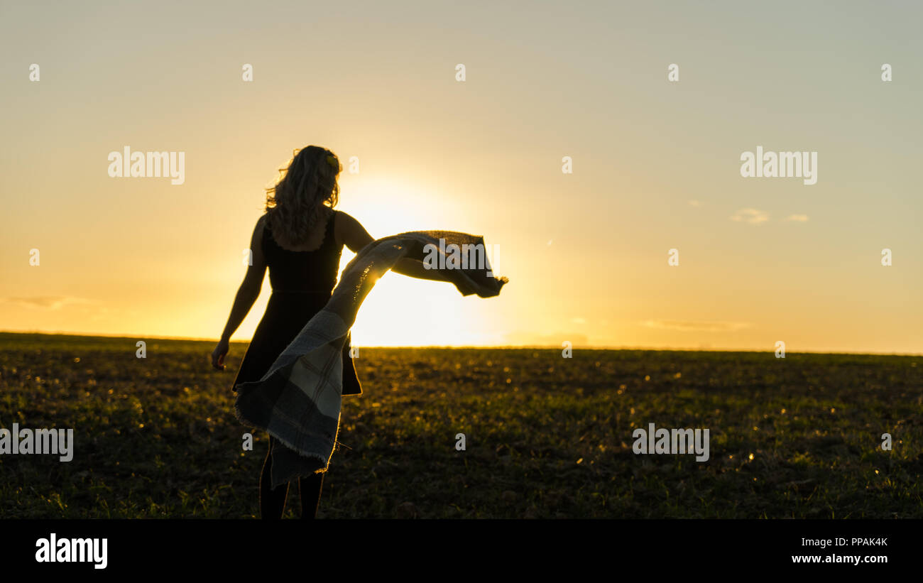 Girl Walking into The Sunset Stock Photo - Alamy