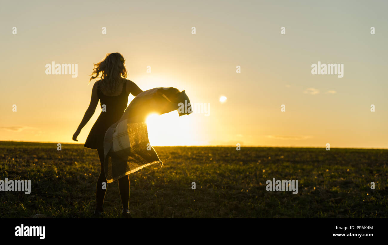 Girl Walking into The Sunset Stock Photo - Alamy