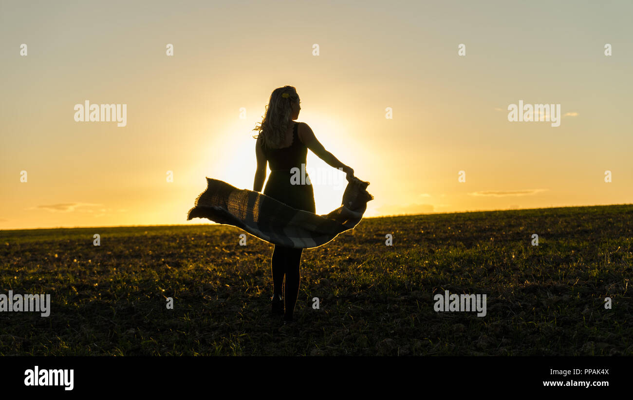 Girl Walking into The Sunset Stock Photo - Alamy