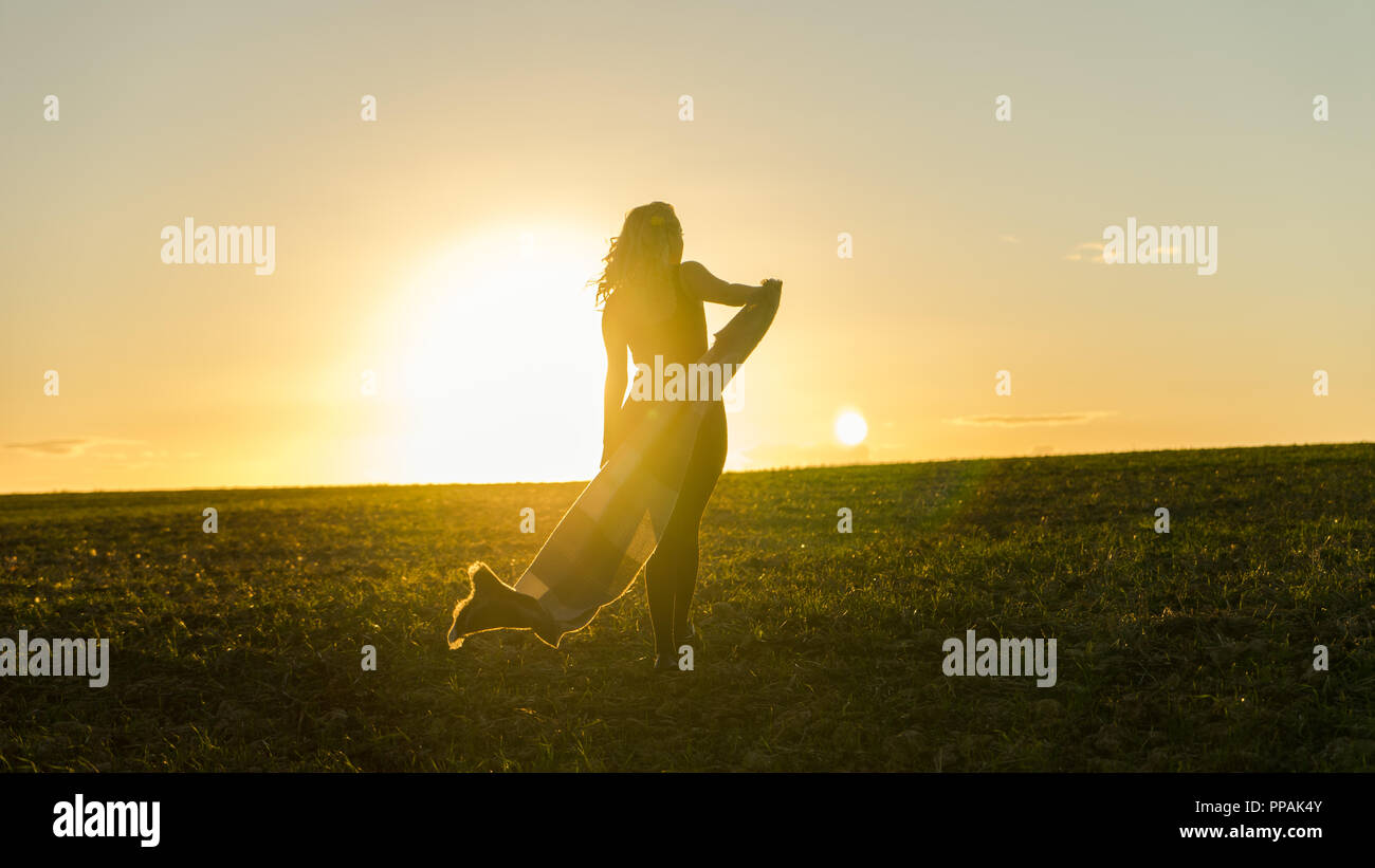 Girl Walking into The Sunset Stock Photo - Alamy