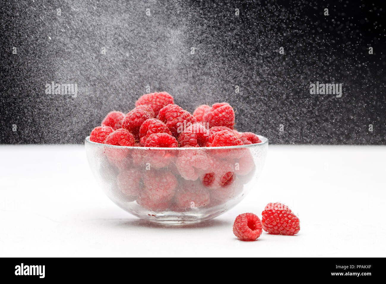 Photo of raspberries in transparent glass cup Stock Photo - Alamy