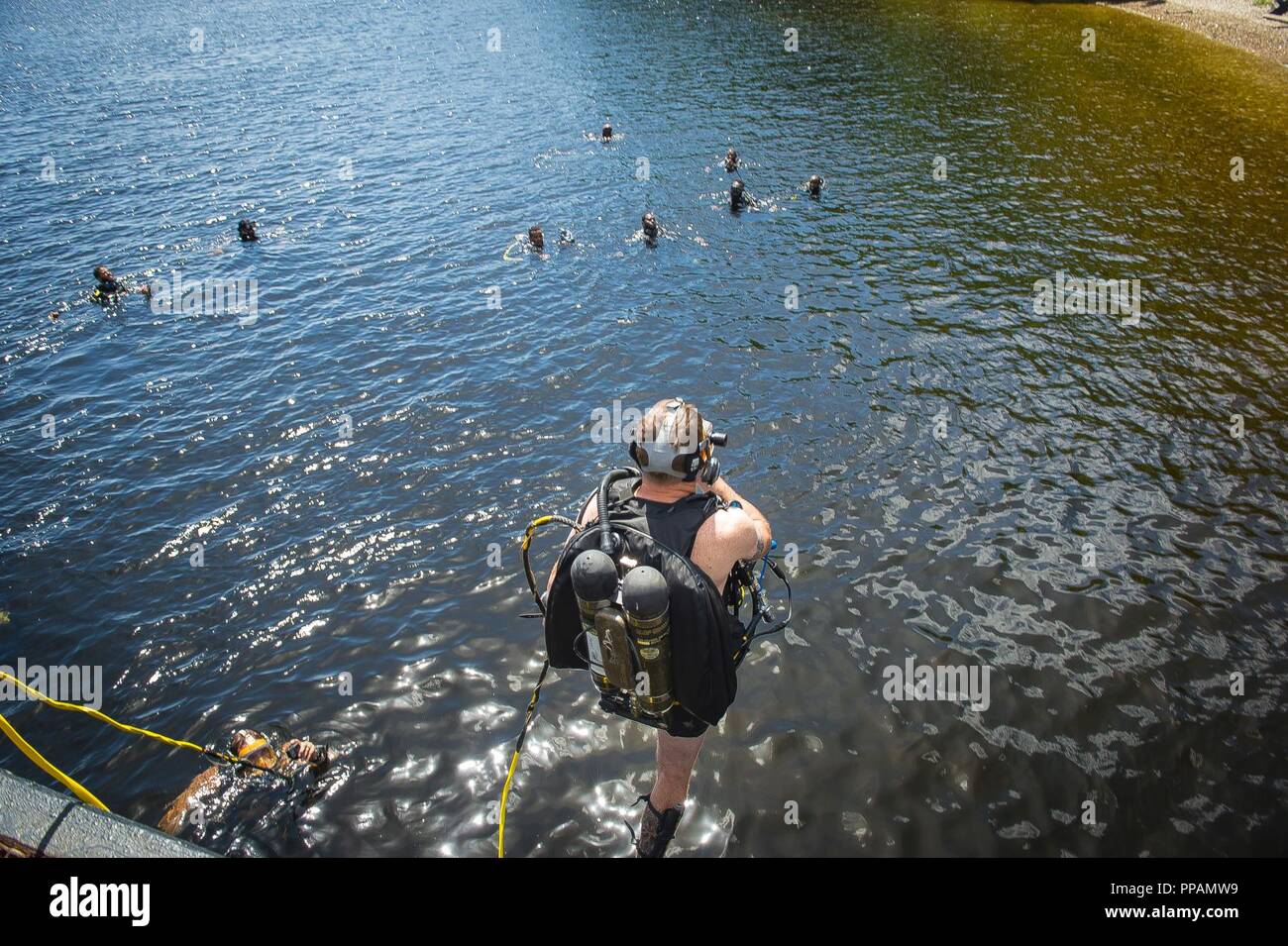 Members of the Trinidad and Tobago Coast Guard dive team observe ...
