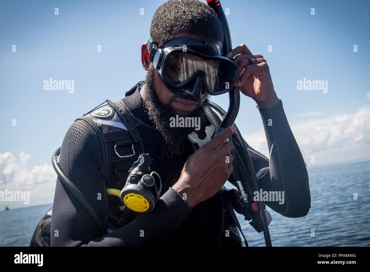A diver from the Trinidad and Tobago Coast Guard conducts pre-dive ...