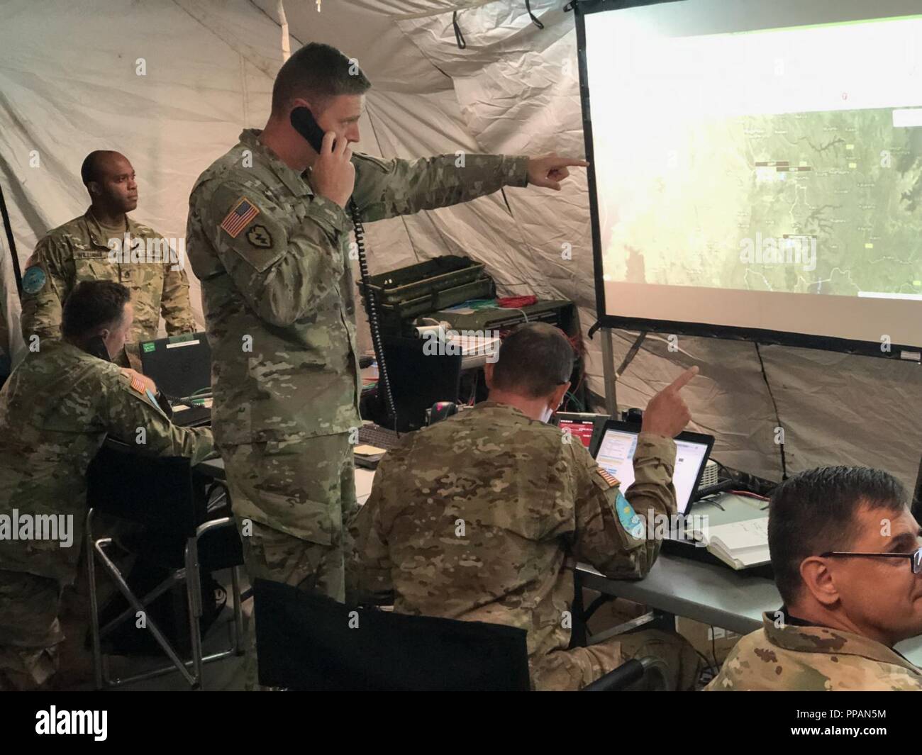 Maj. Daniel Akey, a senior intelligence officer, works with staff to ...