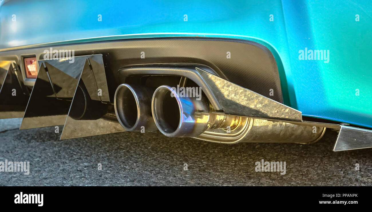 Blue car with dual exhaust pipe and tail spikes Stock Photo - Alamy
