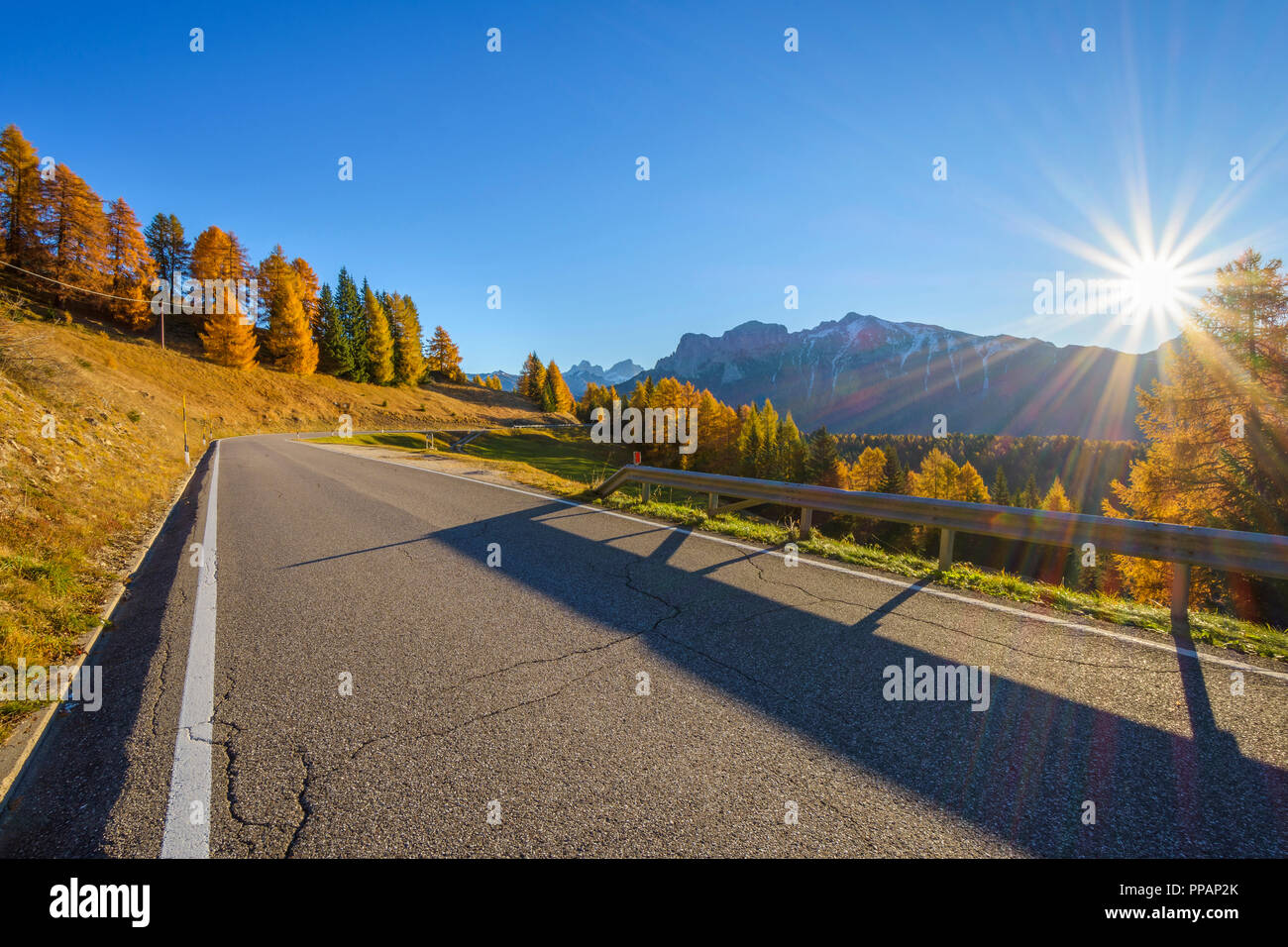 Mountain road with sun in autumn, Vigo di Fassa, Dolomites, Trentino ...