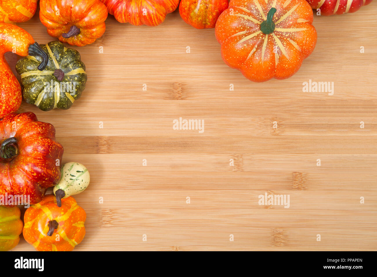 Close up on small pumpkins squash and gourds creating a half square ...