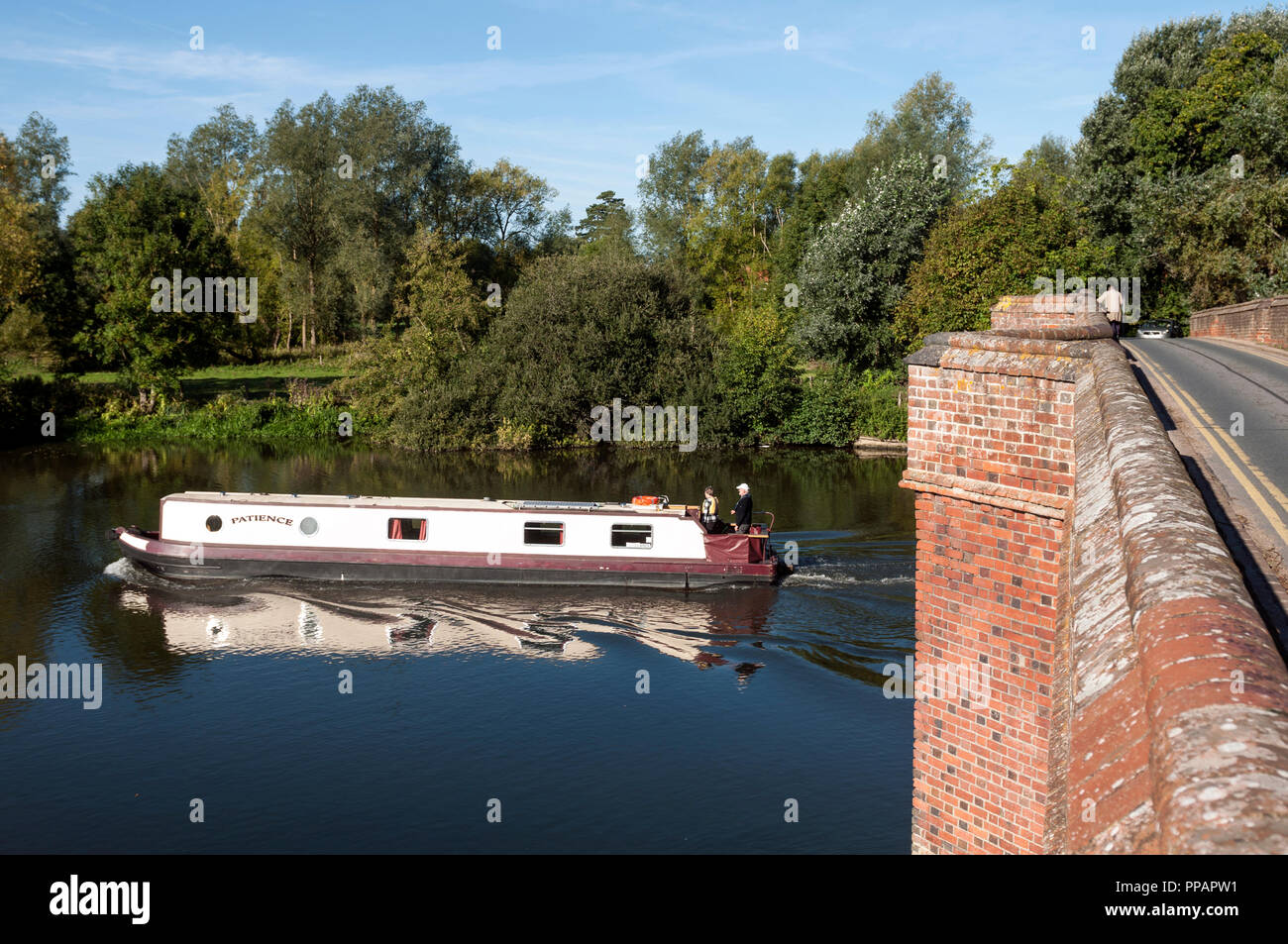 Narrowboat on the River Thames at Clifton Hampden bridge, Oxfordshire ...