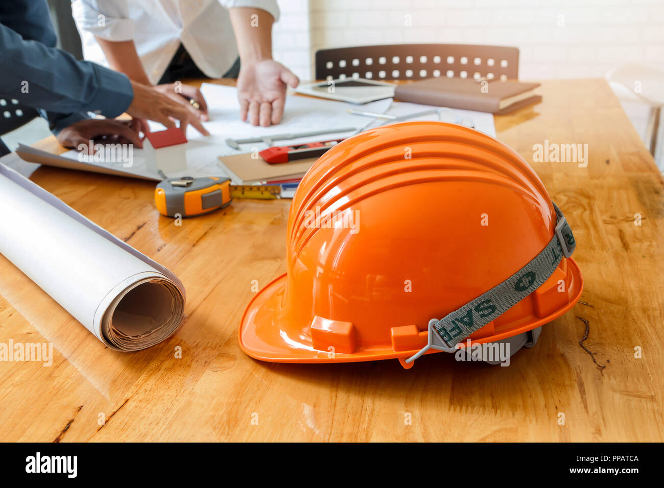 helmet on wooden desk with architect background Stock Photo - Alamy