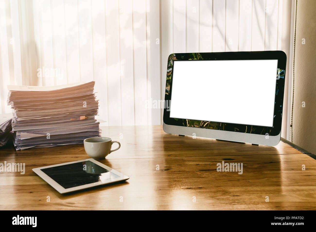 Monitor and office supplies on office desk. Wooden table with office ...