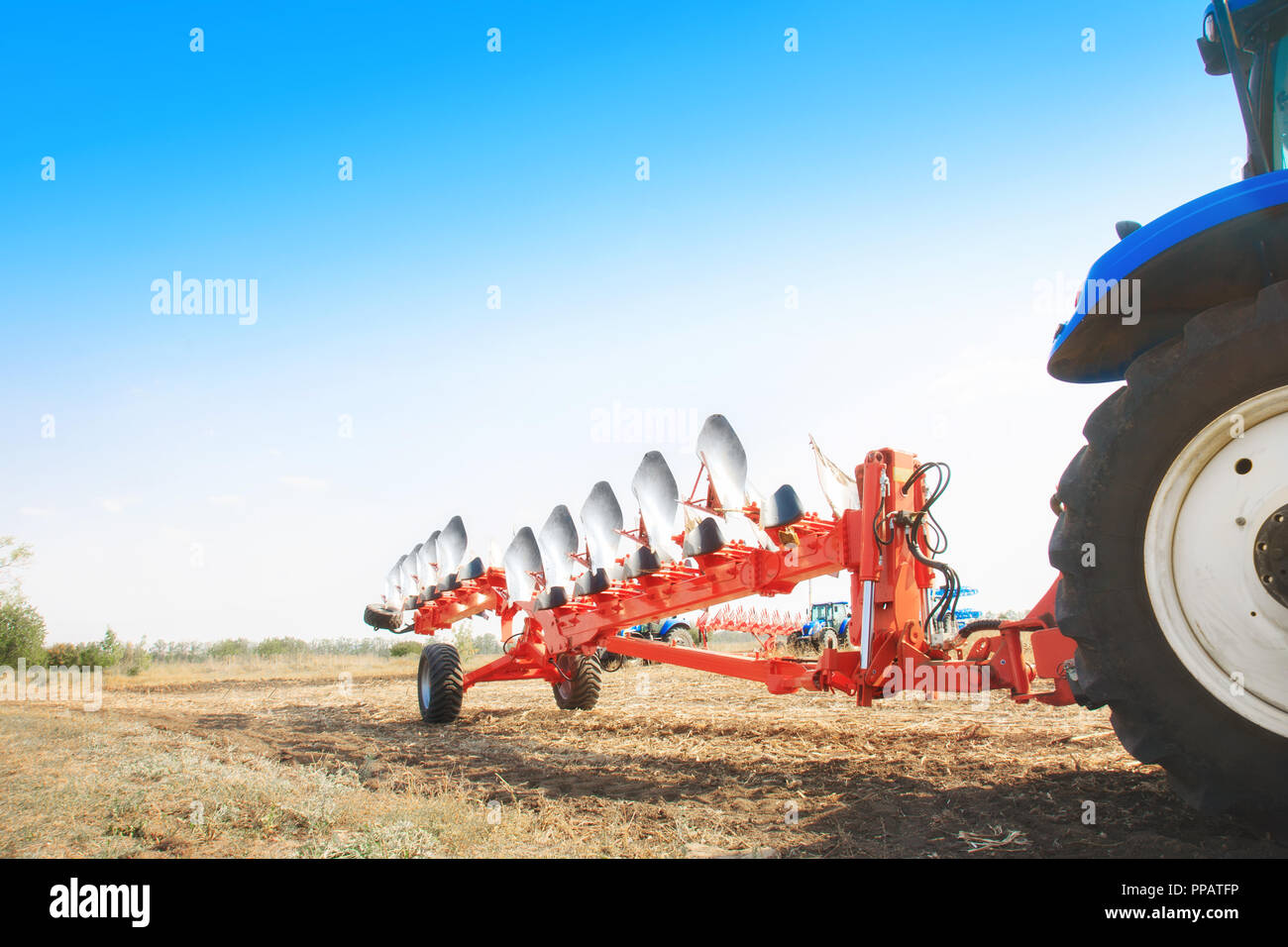 Tractor in the field with a plow. The concept of work in a fields and ...