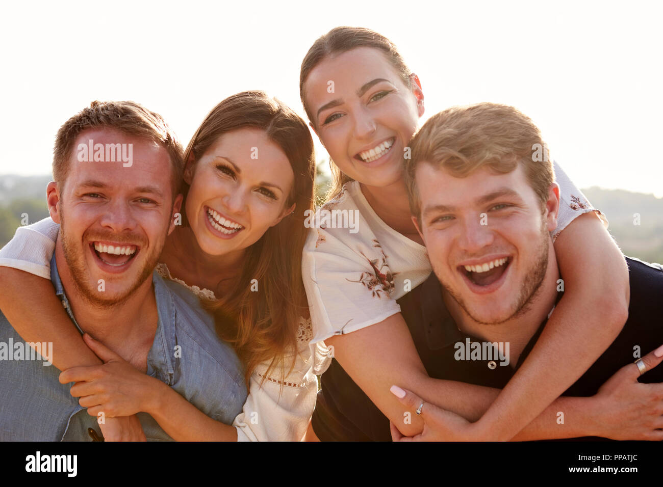 Portrait Of Young Couples Having Fun On Holiday Together Stock Photo ...