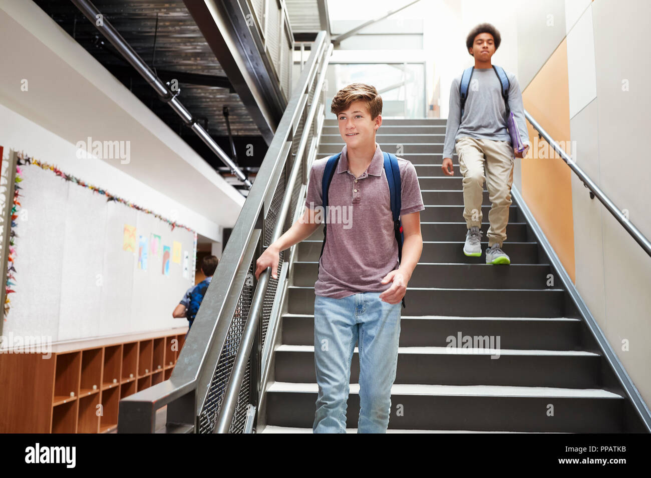 High School Students Walking Down Stairs In Busy College Building Stock ...