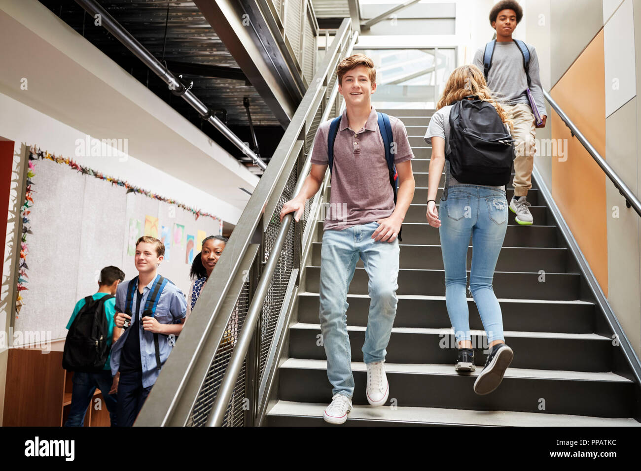 High School Students Walking Down Stairs In Busy College Building Stock ...