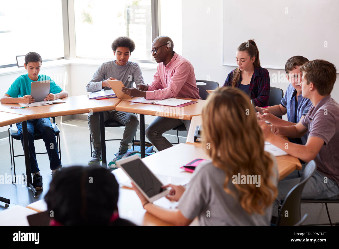 High School Teacher With Pupils Using Digital Tablets In Technology ...