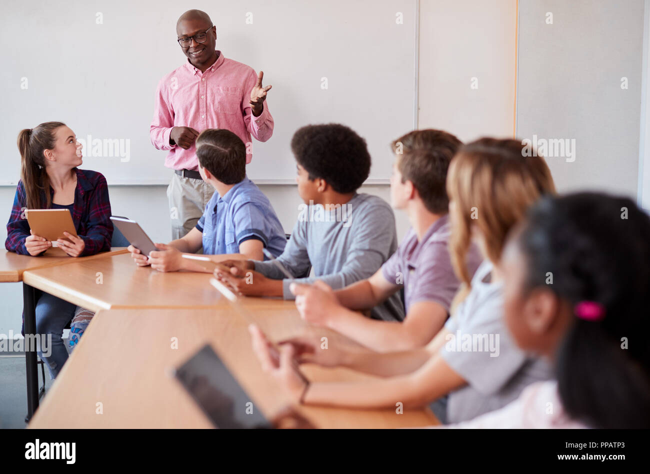 High School Teacher With Pupils Using Digital Tablets In Technology ...