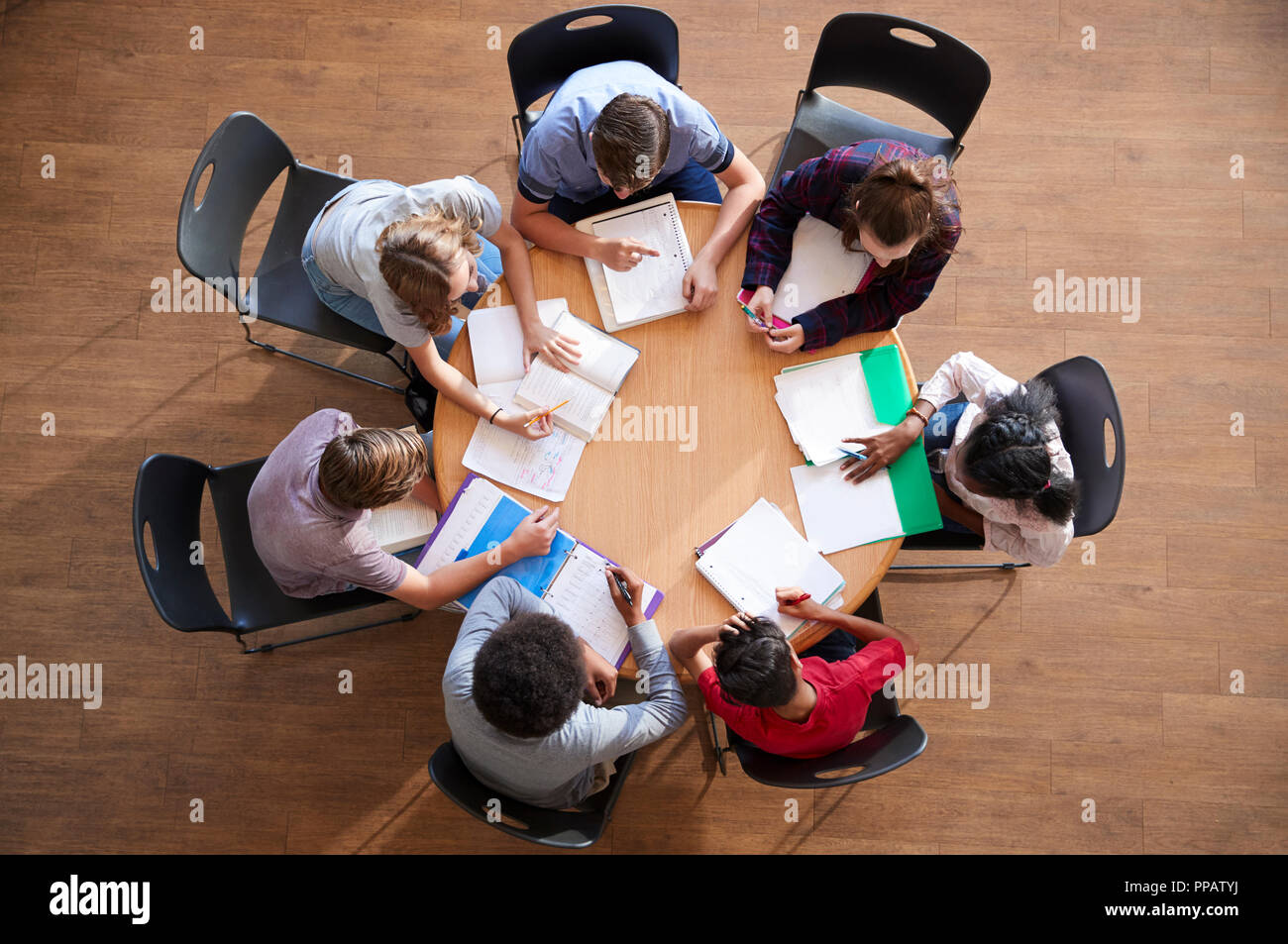 Overhead Shot Of High School Pupils In Group Study Around Tables Stock ...