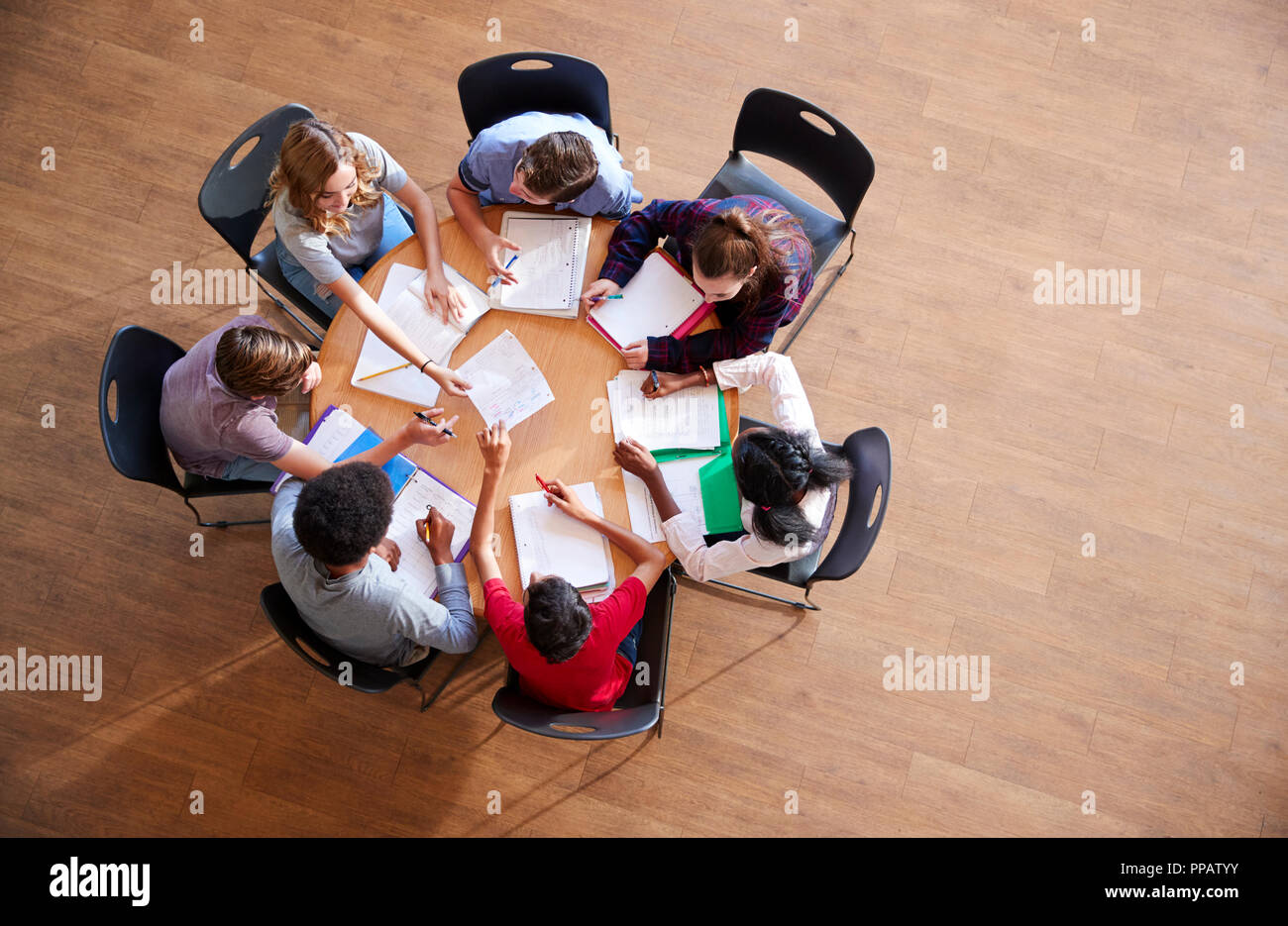 Overhead Shot Of High School Pupils In Group Study Around Tables Stock ...