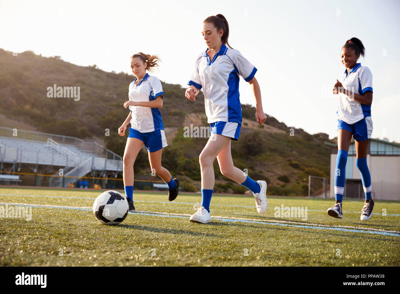 Three school girls playing ball hi-res stock photography and images - Alamy