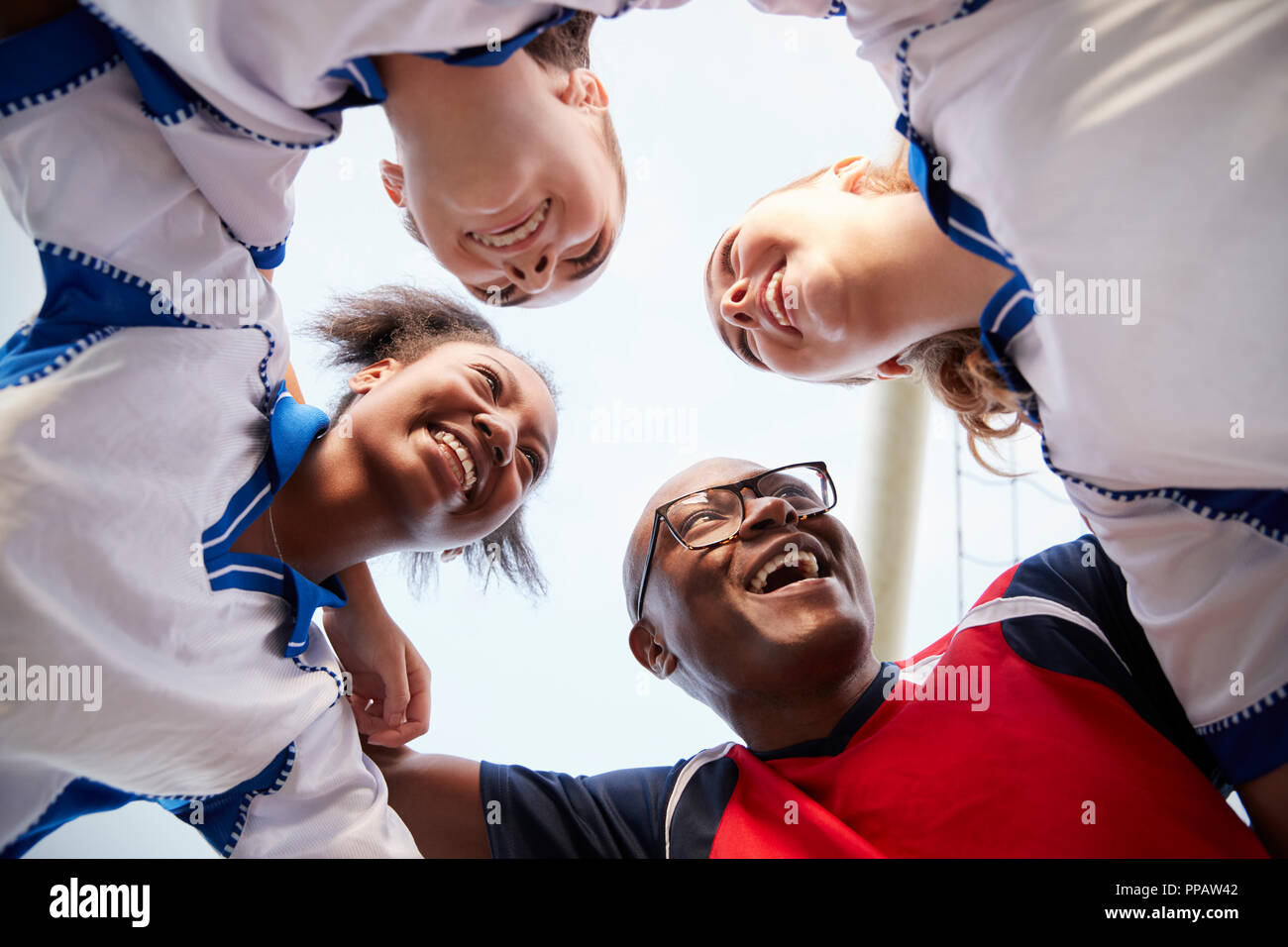 Low Angle View Of Female High School Soccer Players And Coach Having ...