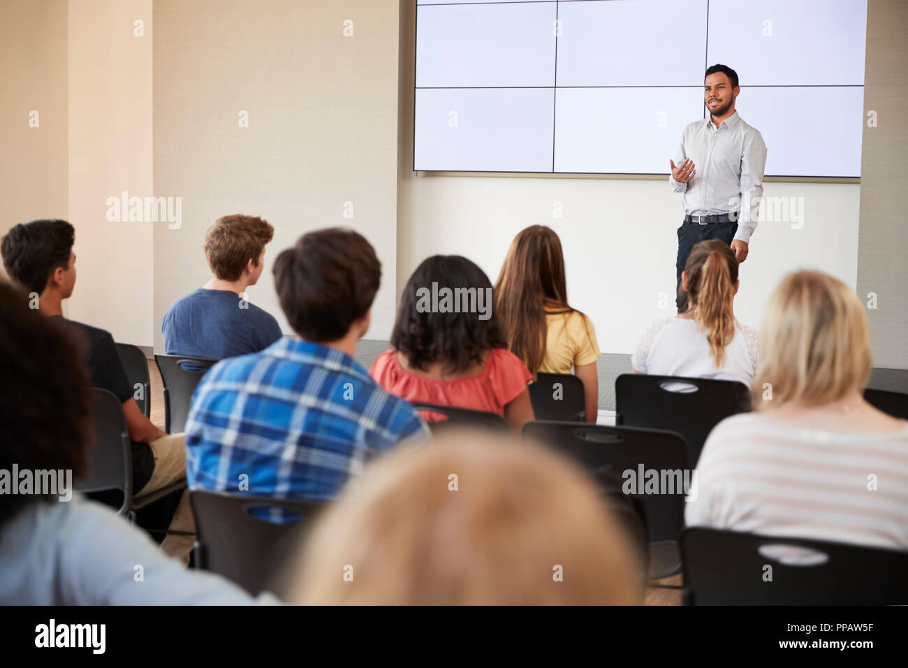 Teacher Giving Presentation To High School Class In Front Of Screen ...