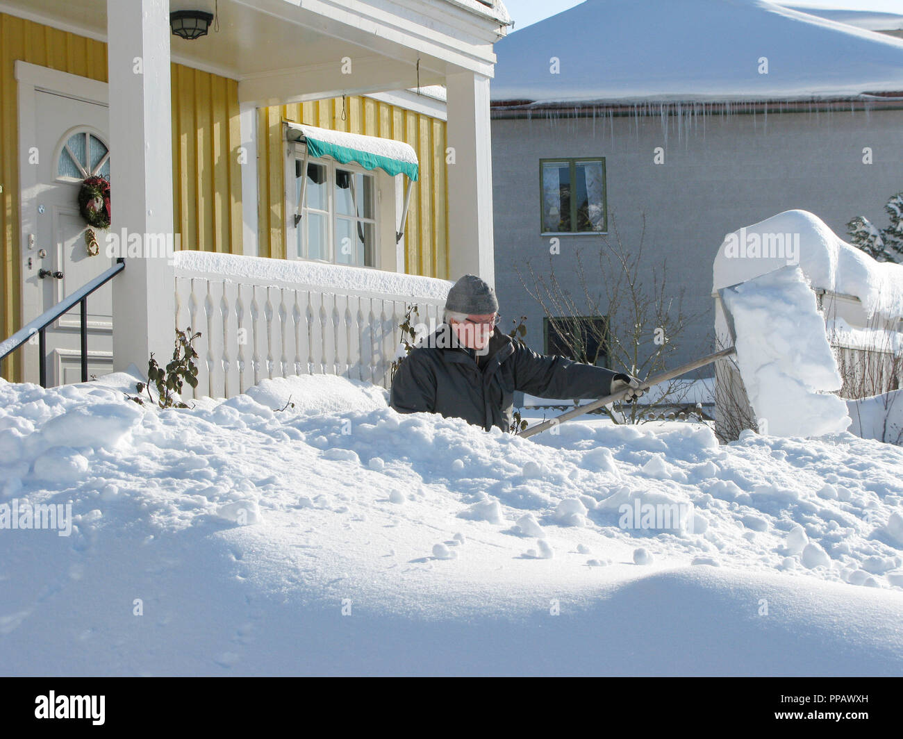 SHOVEL SNOW outside house Stock Photo - Alamy