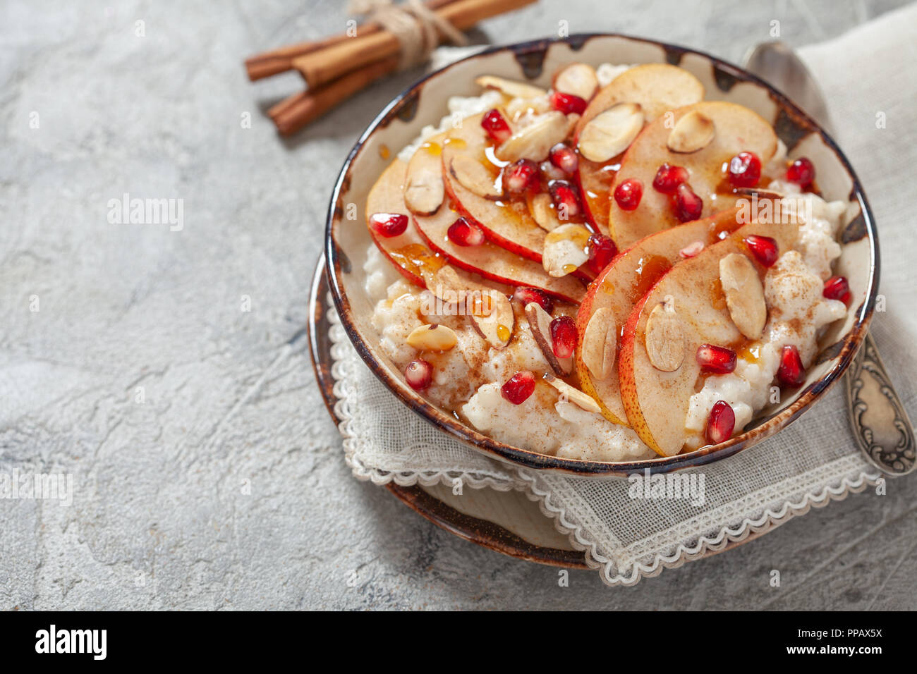 Coconut rice with pomegranate, pear and almond slices Stock Photo - Alamy