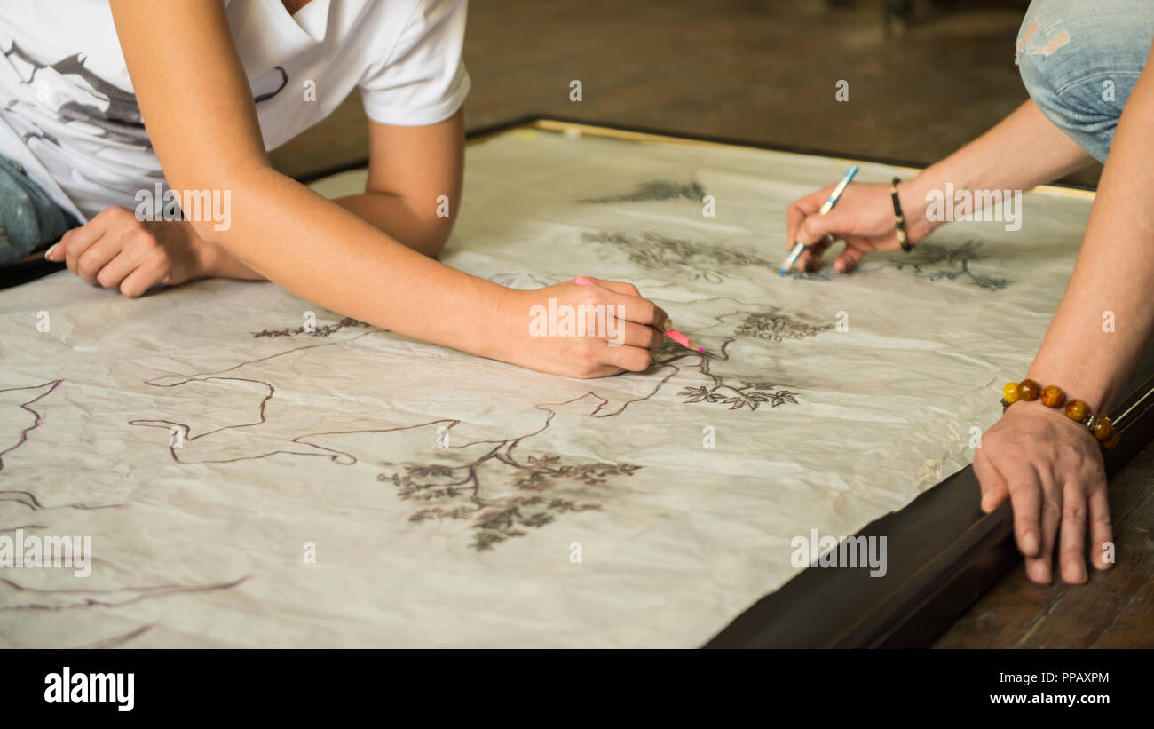 two girls painters draw a sketch through tracing paper, close-up Stock ...