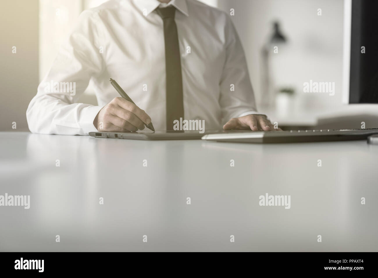 Graphic designer or photographer using a tablet and stylus pen to do ...