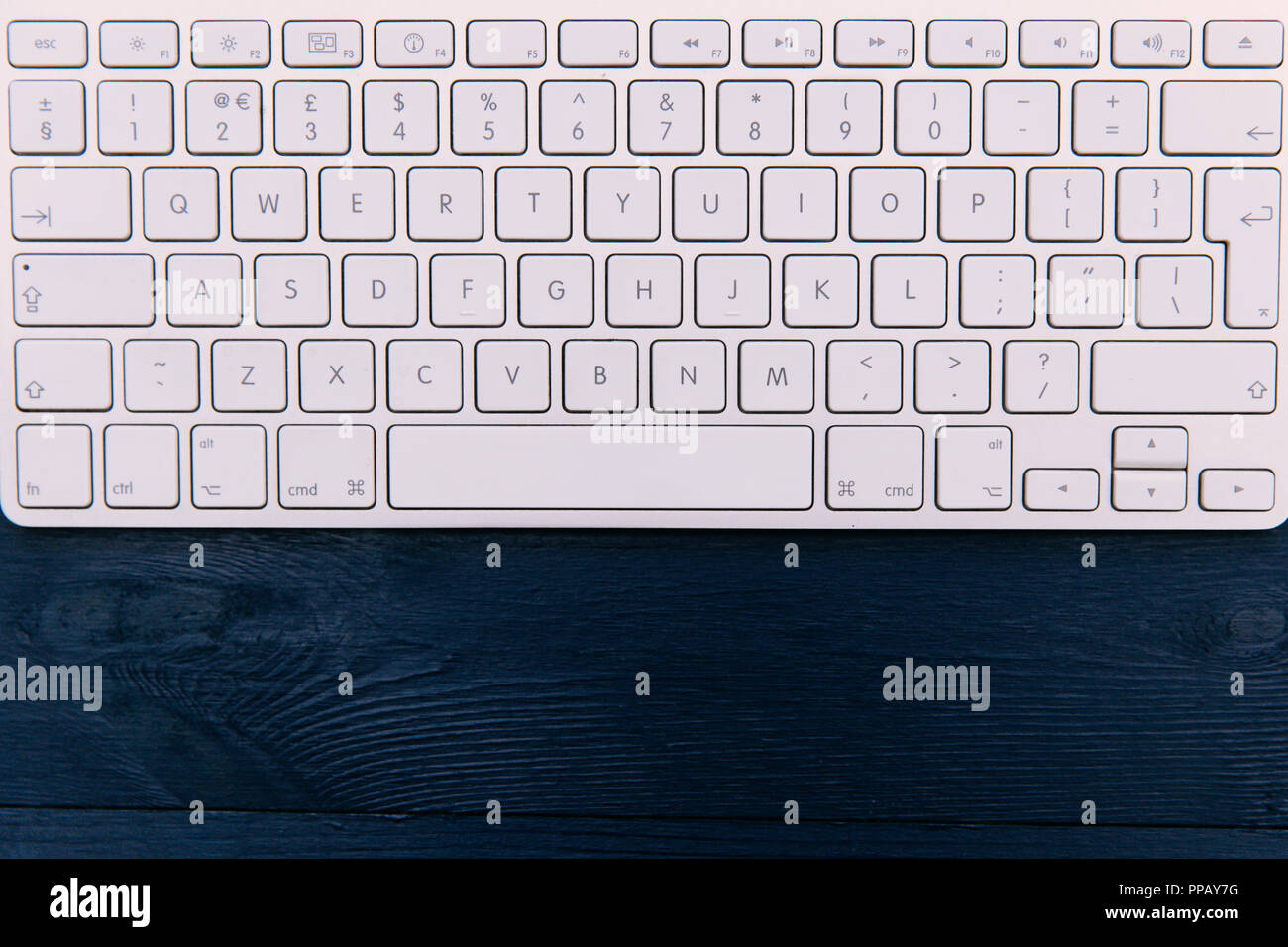 Computer keyboard on wood office desk Stock Photo - Alamy