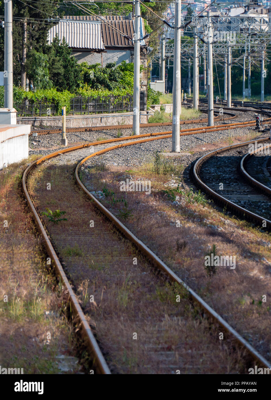 Railway tracks with electric poles Stock Photo - Alamy