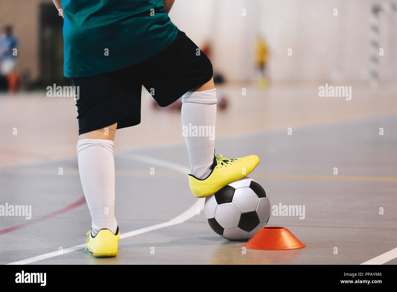 Indoor soccer player training with balls. Indoor soccer sports hall ...