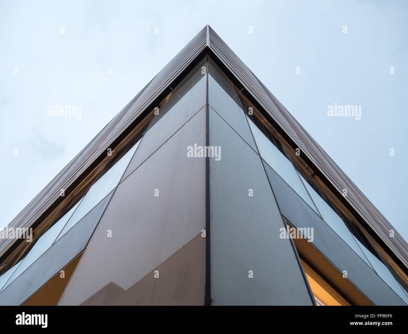 Corner of a skyscraper under a cloudy and cold sky scene from the ...