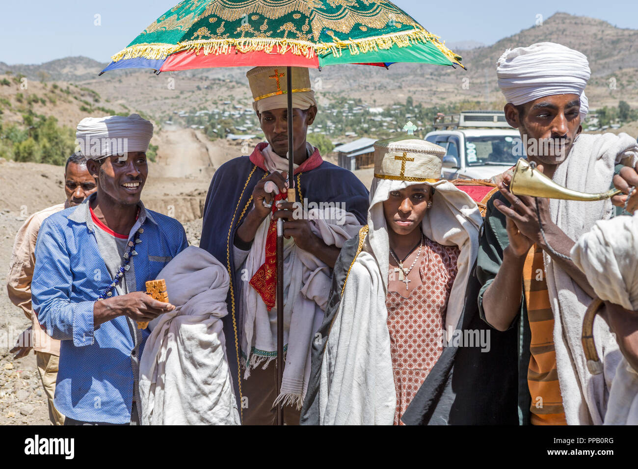 Local religious wedding procession of groom taking wife from her house ...