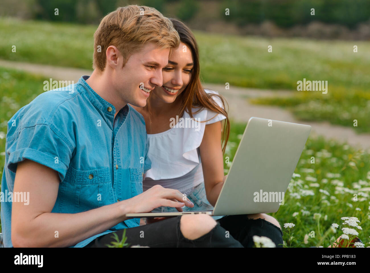 Boy and girl use the Internet outdoors Stock Photo - Alamy