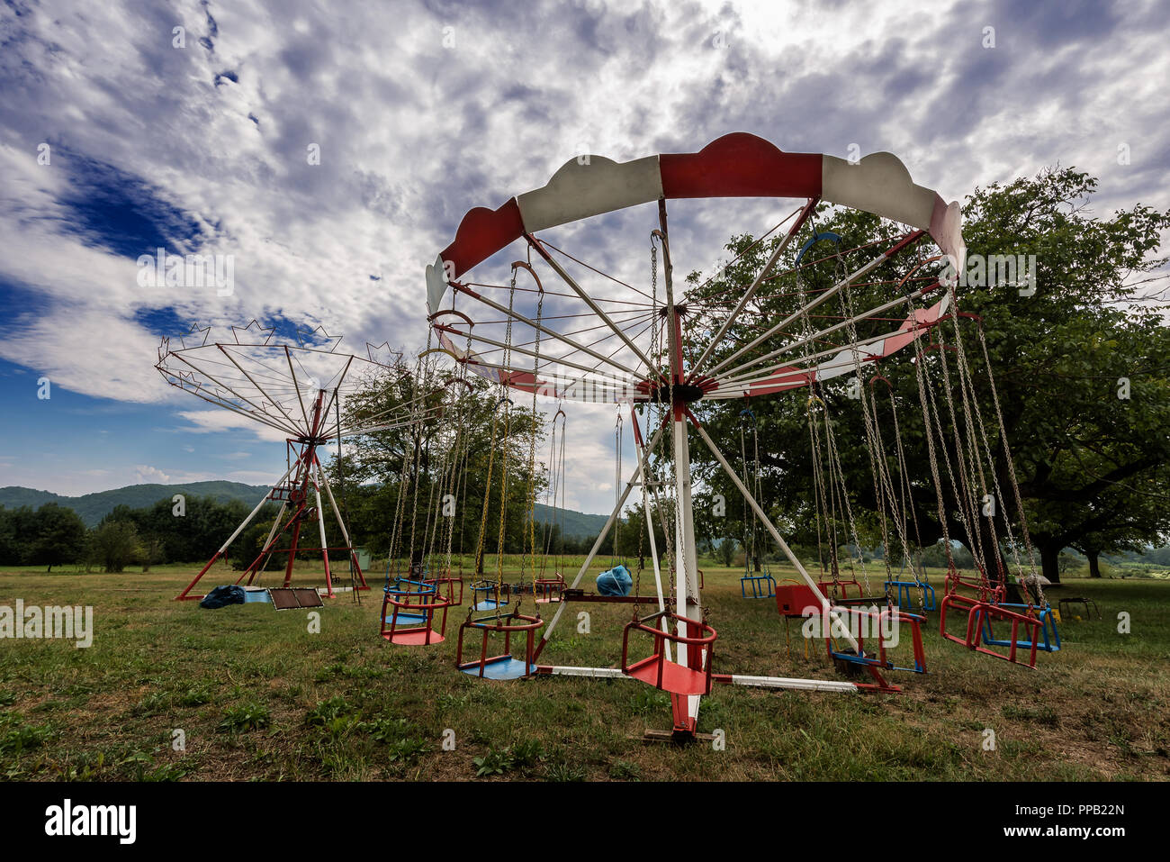 Old abandoned Carousel with Chairs. Merry-go-round in the Countryside ...