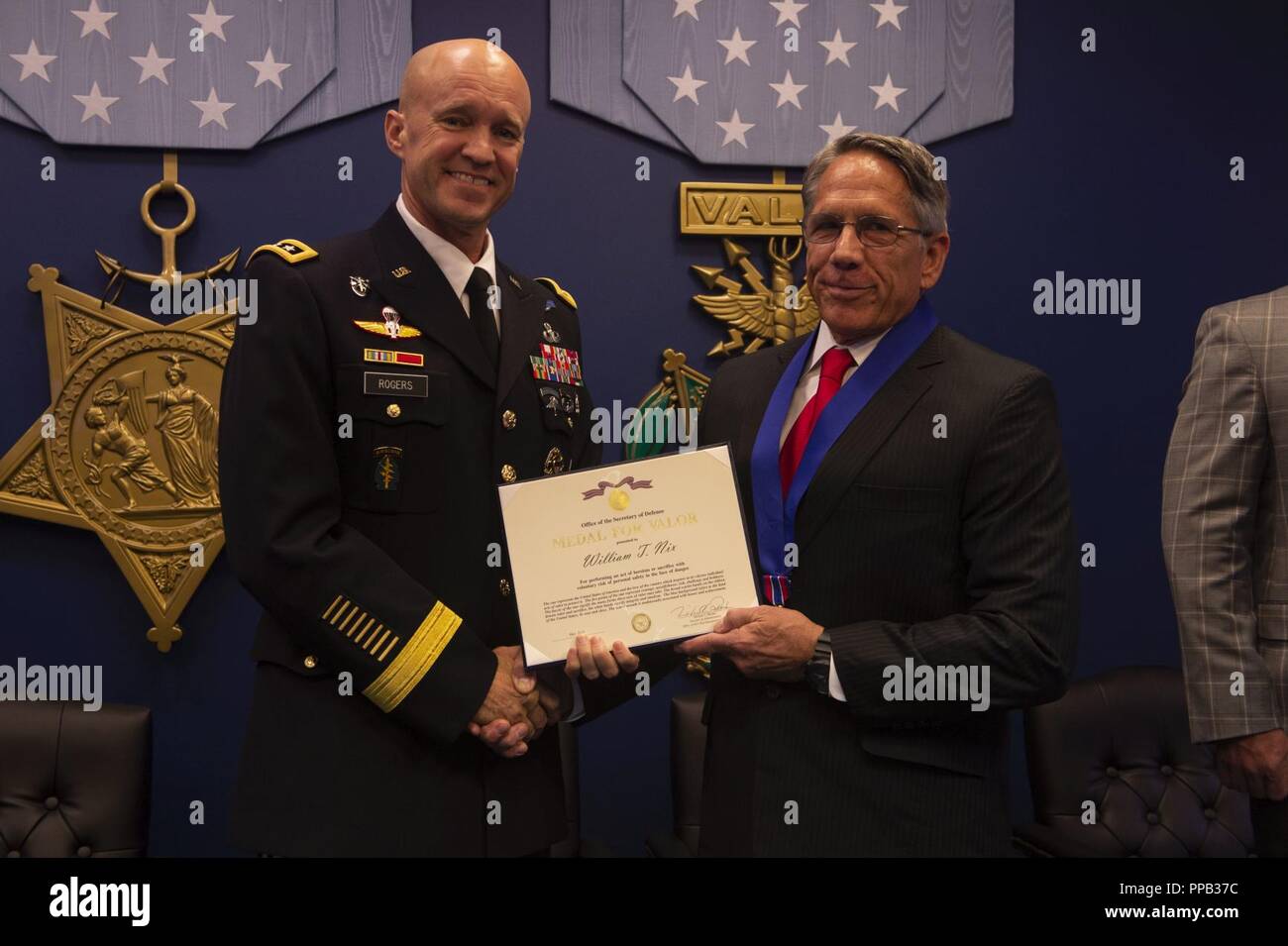William T. Nix, right, is presented with the Medal of Valor by Army Lt ...