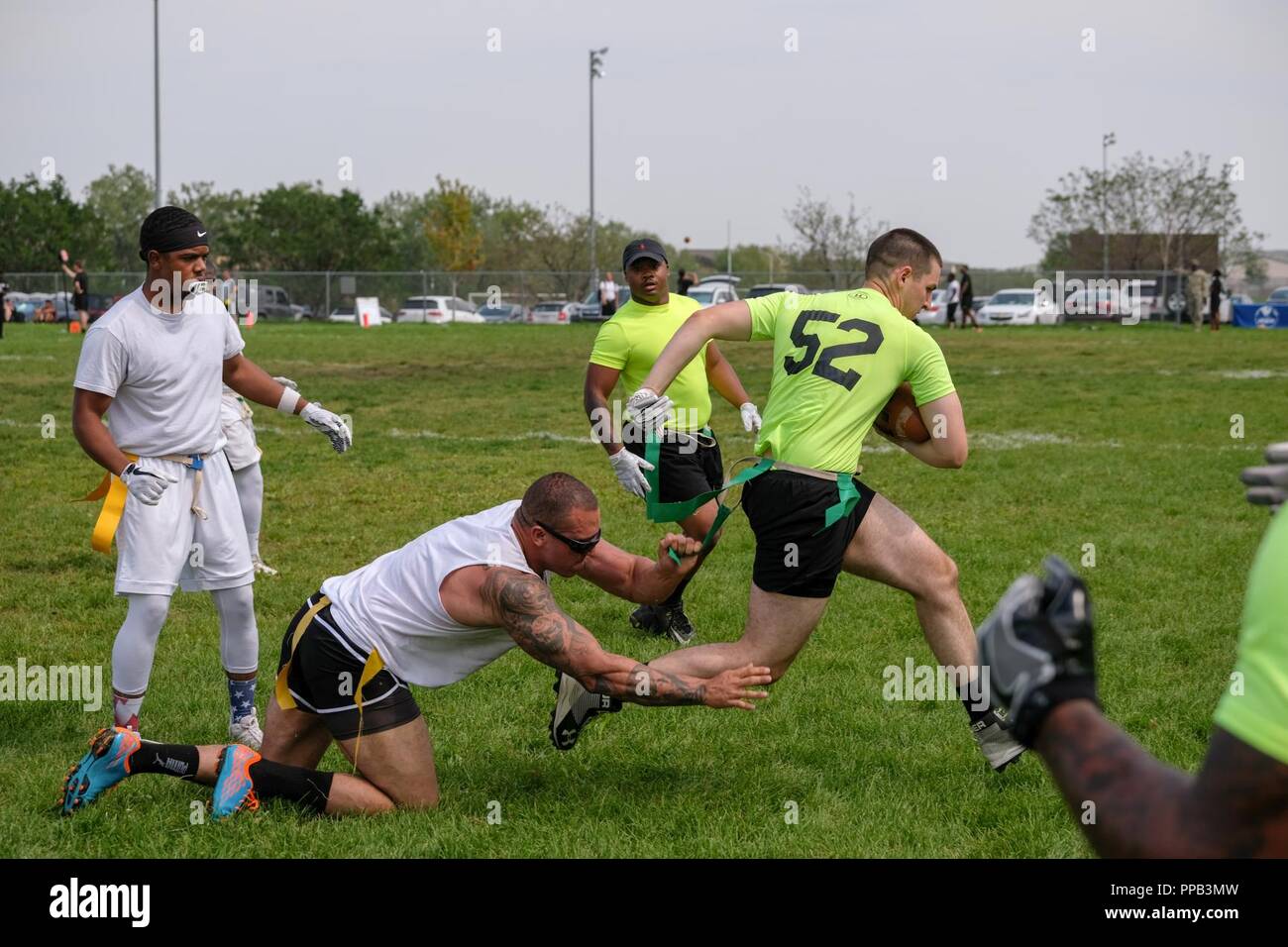 A Soldier evades the defense during a round of flag football during Ivy ...