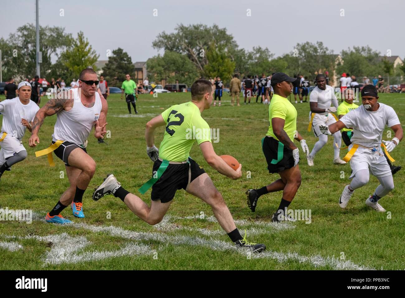A Soldier runs with the football during a round of flag football during ...