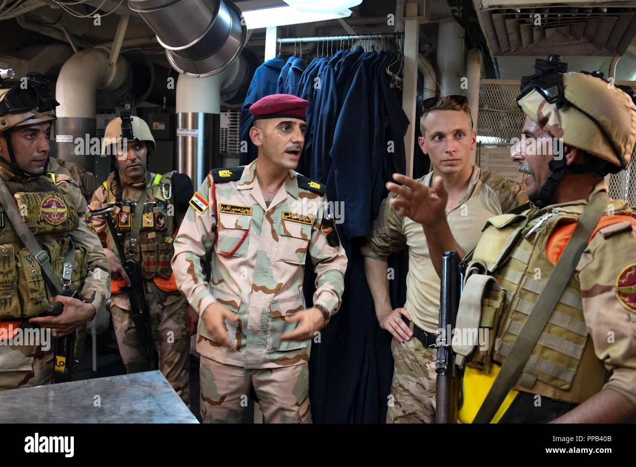 ARABIAN GULF (August 14, 2018) Iraqi navy Maj. Yahya Sameer, middle ...