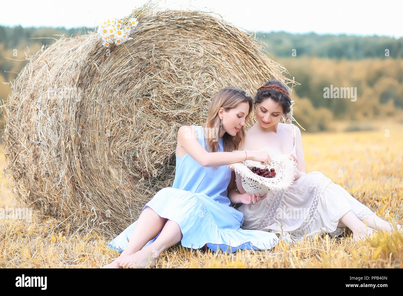 Two girls in dresses in autumn field Stock Photo - Alamy