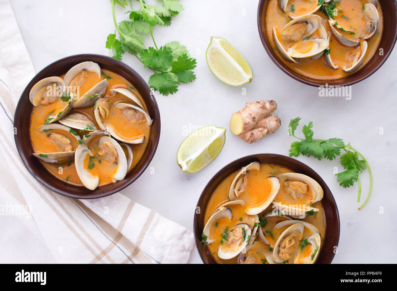 Red Curry, Coconut, and Ginger Infused Steamed Clams Stock Photo - Alamy