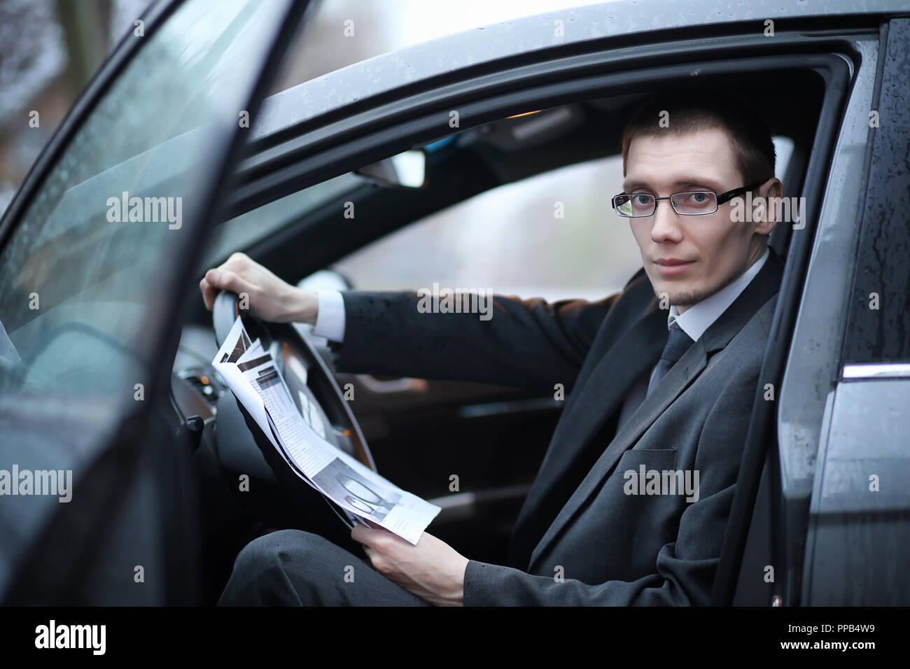 Man in a business suit in the car Stock Photo - Alamy