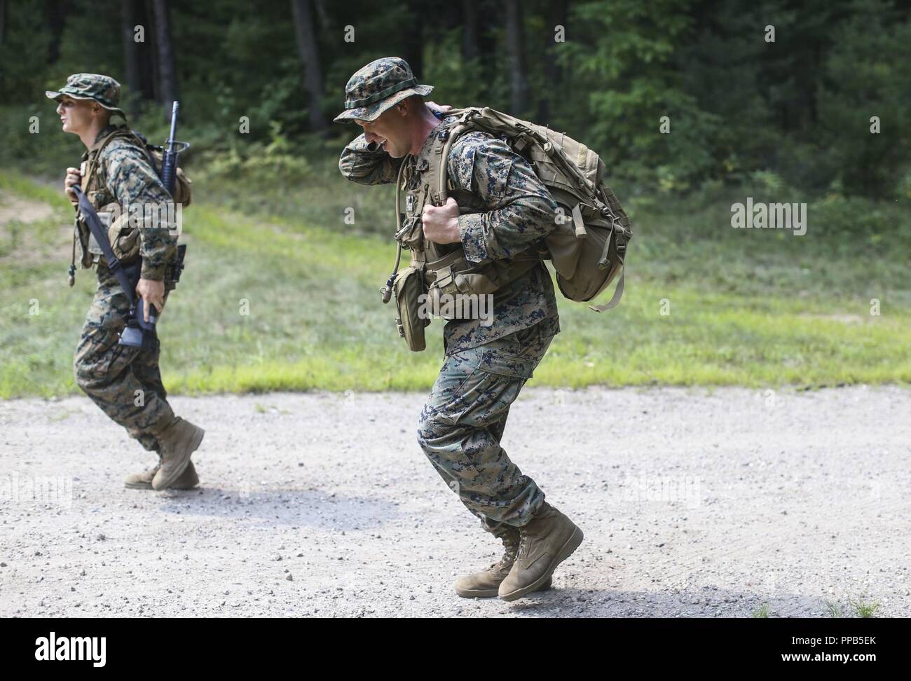 A Marine with Marine Aviation Logistics Squadron (MALS) 13 carries gear ...