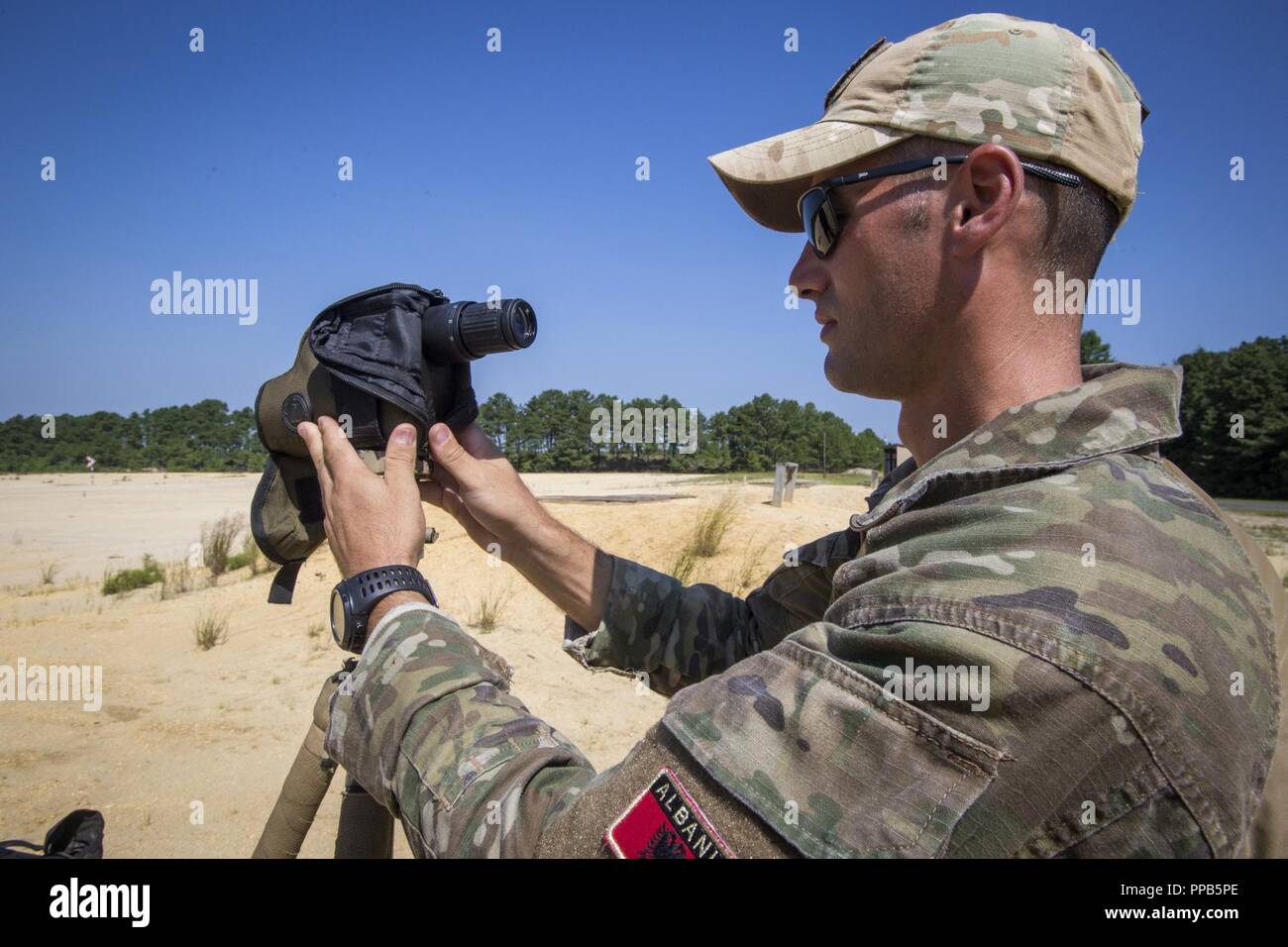 Albanian special forces sniper Staff Sgt. Ajet Disha sets up a spotting ...